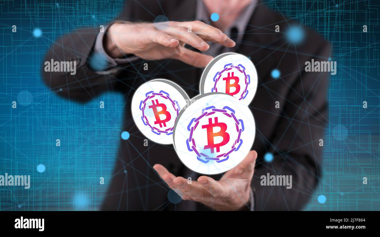 Blockchain concept between hands of a man in background Stock Photo - Alamy