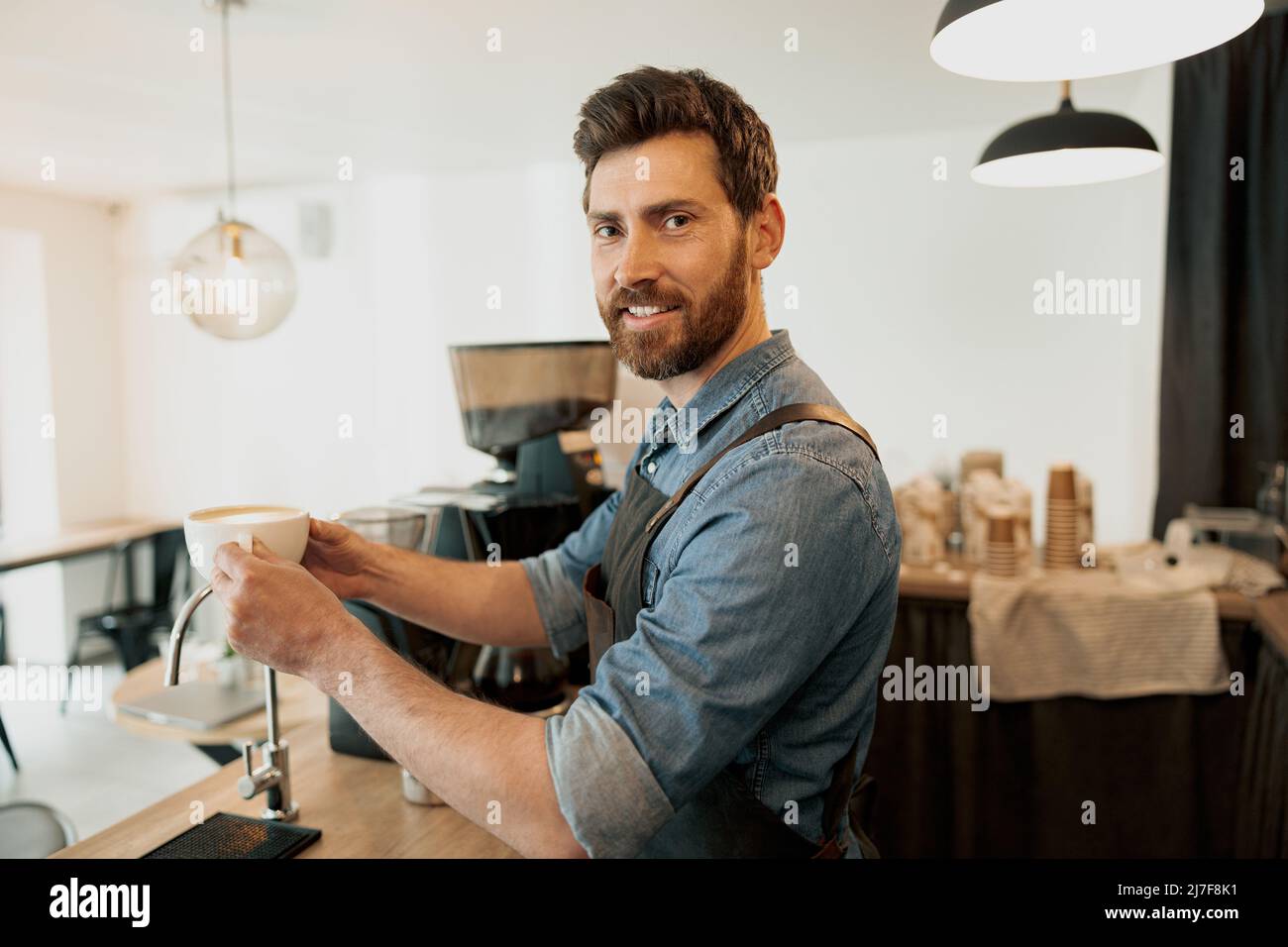 Handsome barista man smiling hi-res stock photography and images - Alamy
