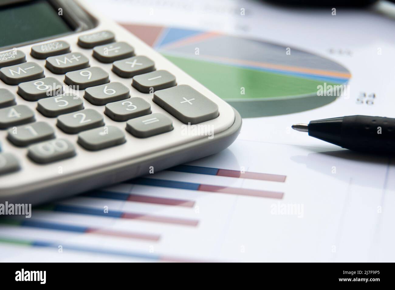 Analysis of data, chart and graphs with calculator and pen. Business ...