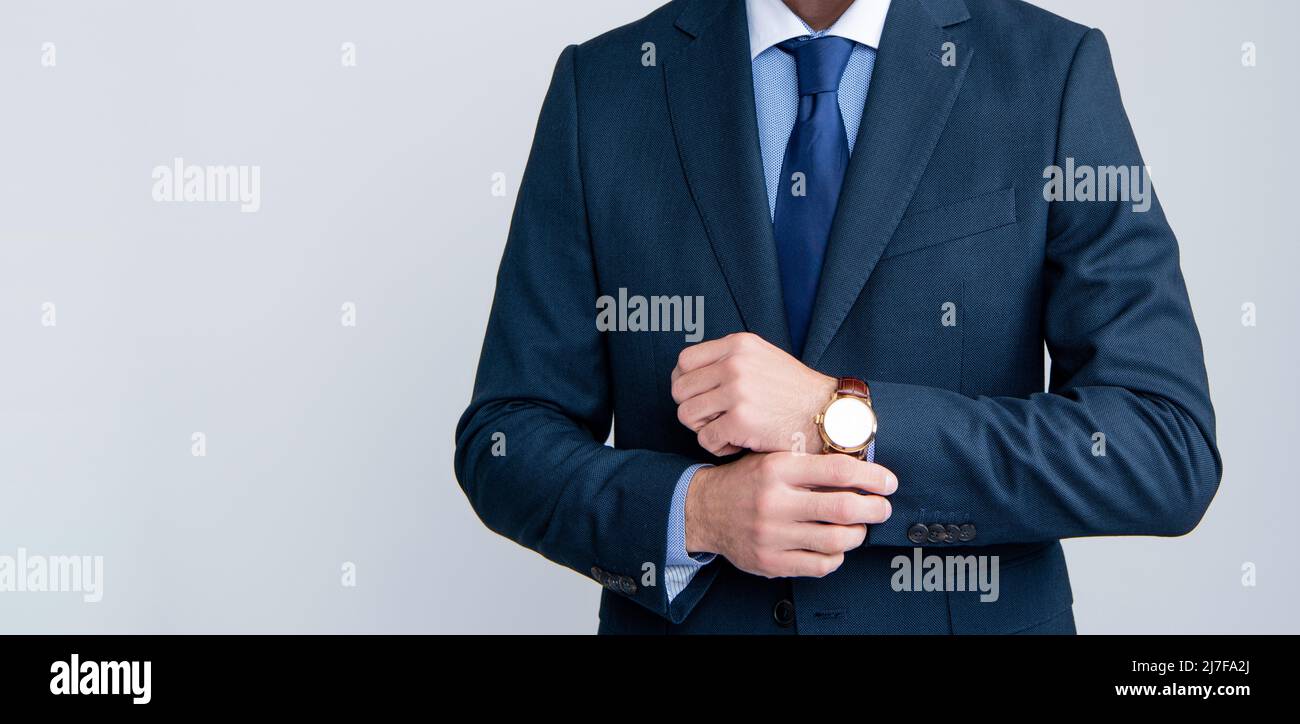 mature ceo wear businesslike suit check time on watch on grey ...