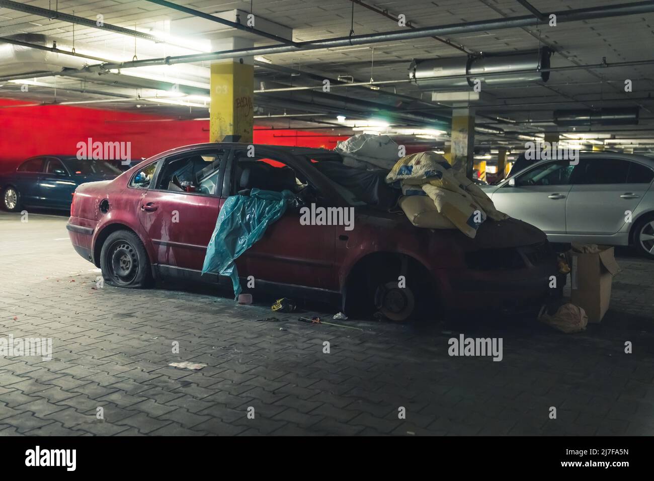 damaged car full of dust, filthy with broken screens used as a landfill ...