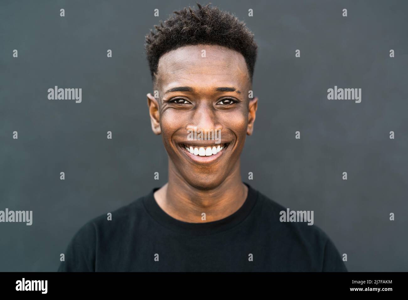 Happy young African teenager smiling in front of camera Stock Photo - Alamy