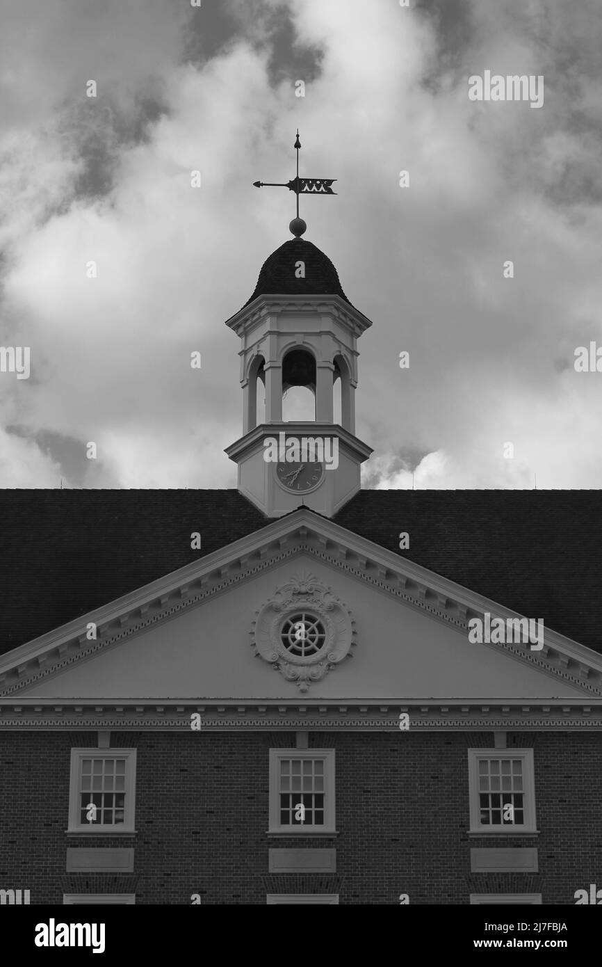 Traditional colonial building with a cupola and a weather vane in black ...