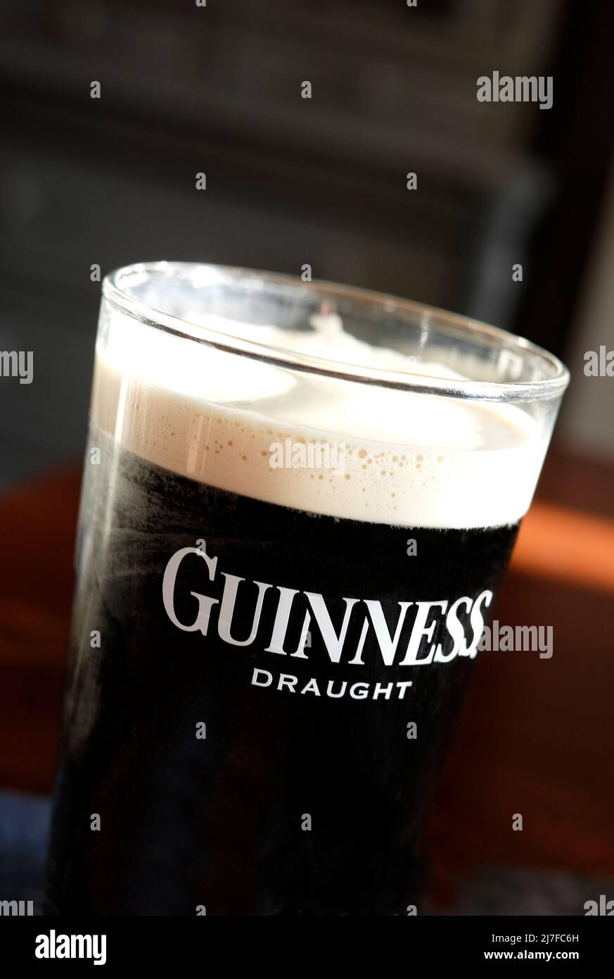 pint of draught guinness in english pub Stock Photo - Alamy