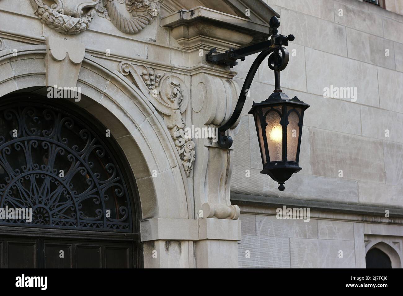 Vintage cast iron decorative street lamp hanging on the wall of the ...