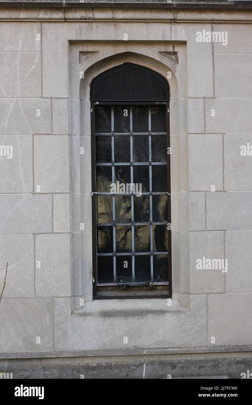 Medieval gothic windows with panes on a solid stone wall in black and ...