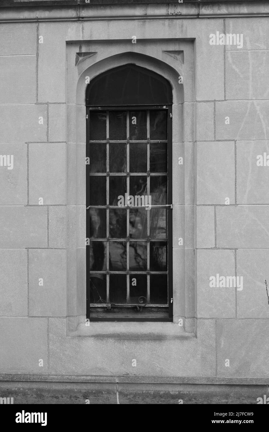 Medieval gothic windows with panes on a solid stone wall in black and ...