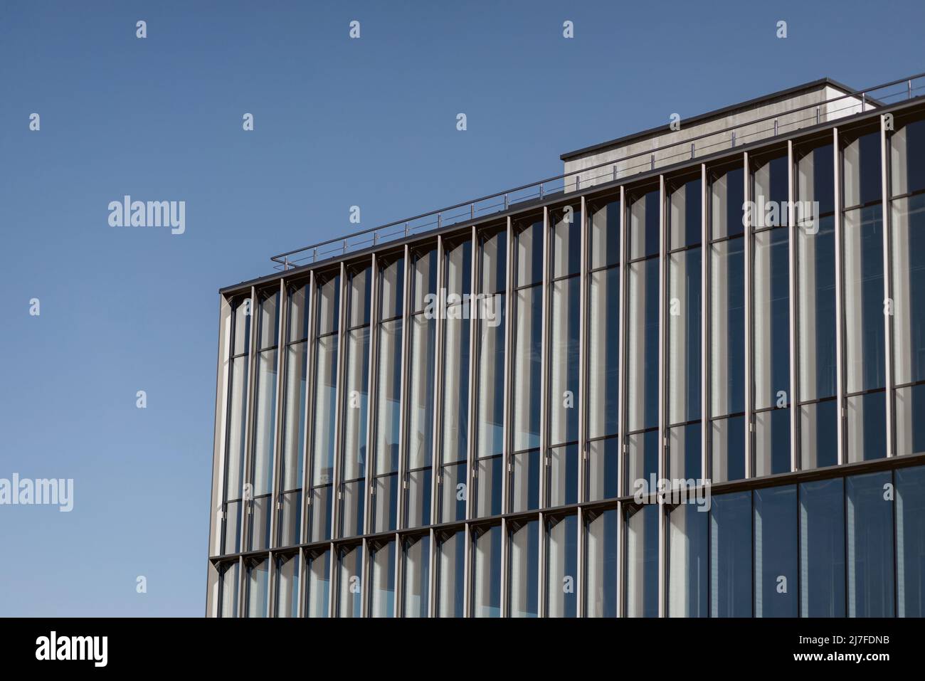 Abstract image of the facade of a modern building covered in reflective ...