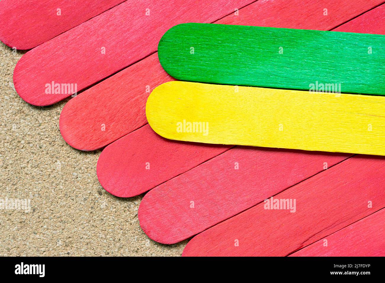 yellow and red color wooden stick on wooden desk.Flat lay. Directly ...