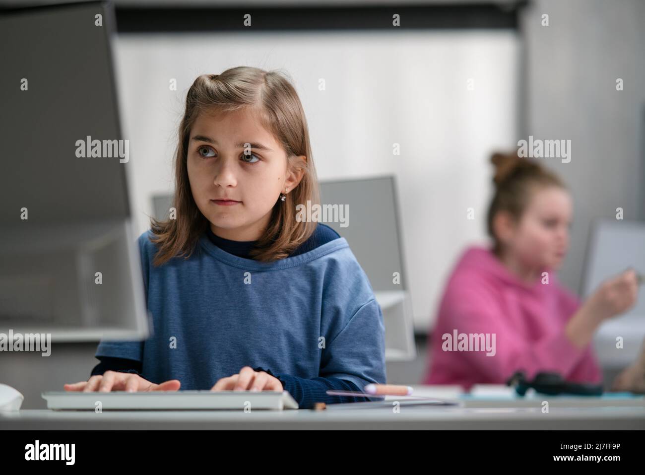 School kids using computer in classroom at school Stock Photo - Alamy