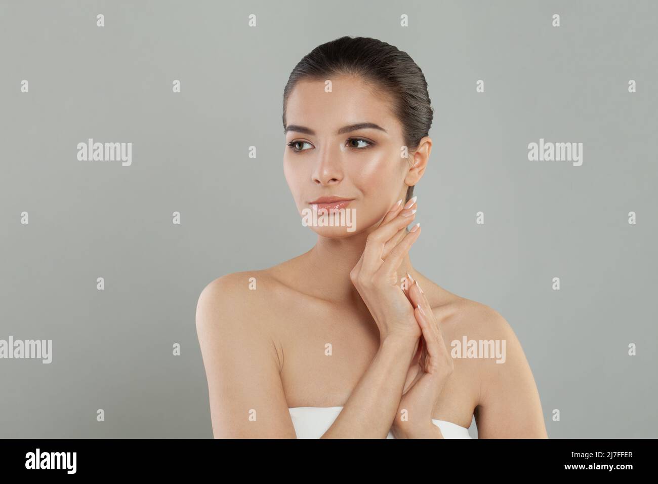 Stylish woman. Beautiful female face on grey background Stock Photo - Alamy