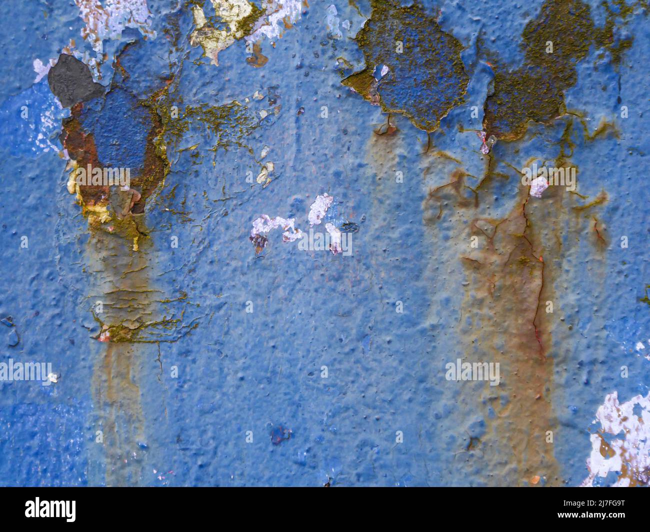 blue painted metal pillar with rust blisters and clear traces of ...