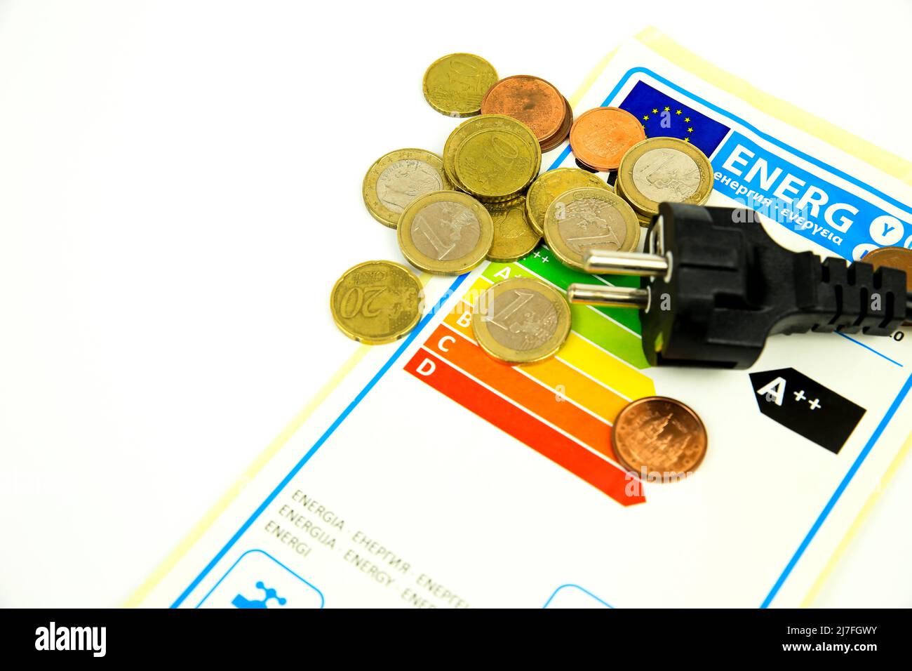 European Union Energy Label next to black pin power plug and coins ...