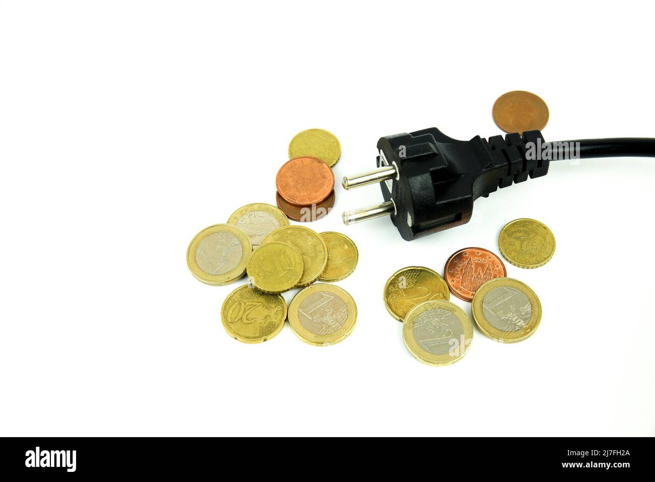 Black pin power plug and coins on white background Stock Photo - Alamy