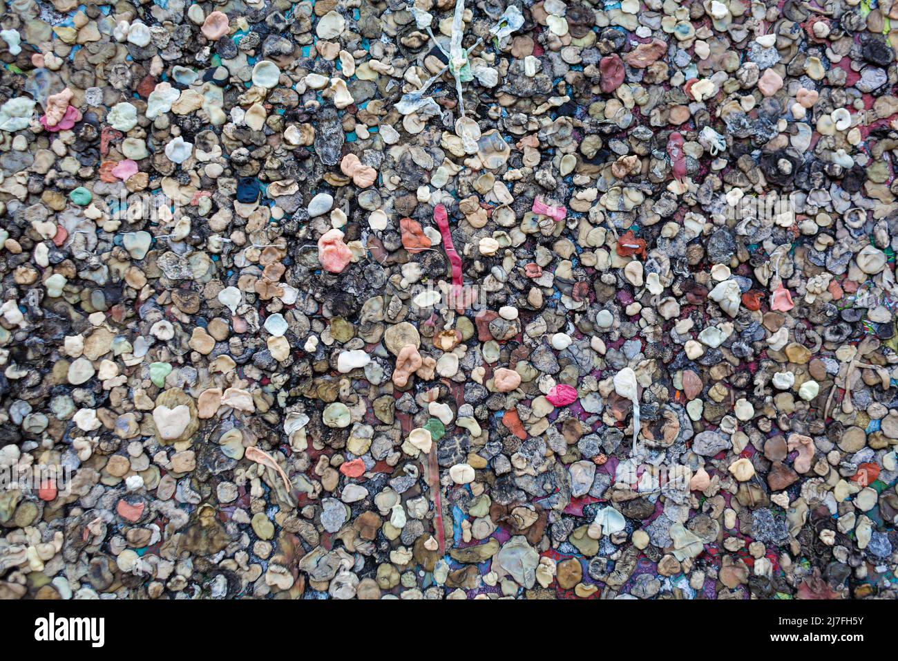 The texture of the landmark Berlin Wall is covered with chewing gum ...