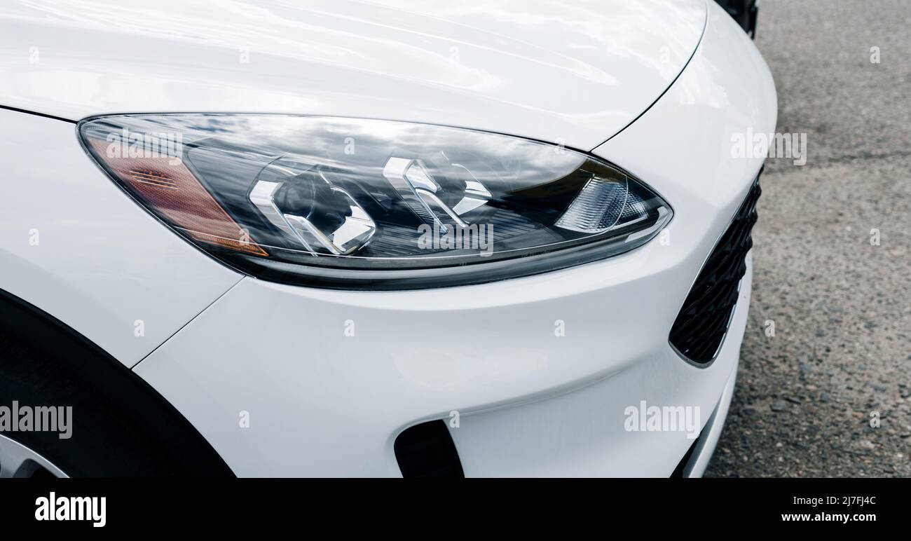 Detail of the LED headlights of a white car. front lamp automobile ...