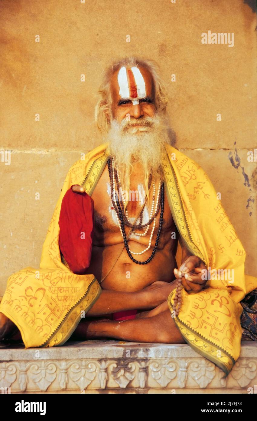 Portrait of a Hindu sadhu sitting cross-legged, Varanasi, Uttar Pradesh ...