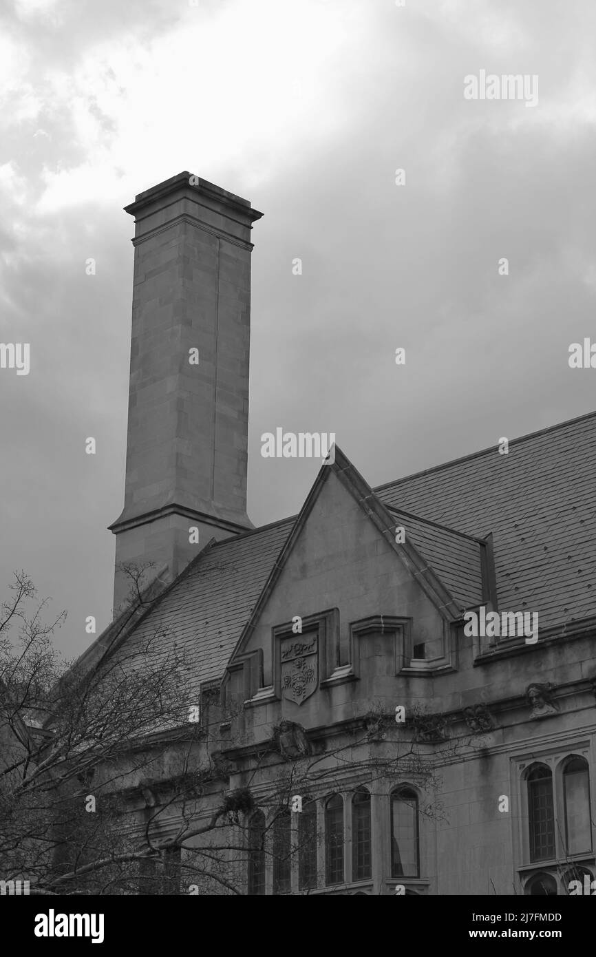 Traditional colonial building with a brick chimney in black and white ...