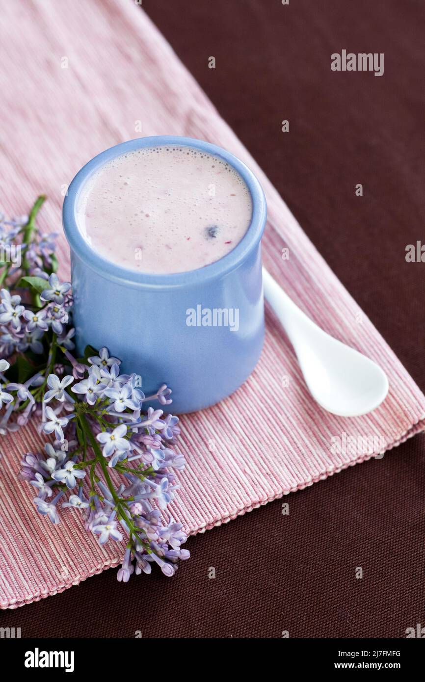 Homemade yogurt with berries and a bouquet of spring flowers Stock ...