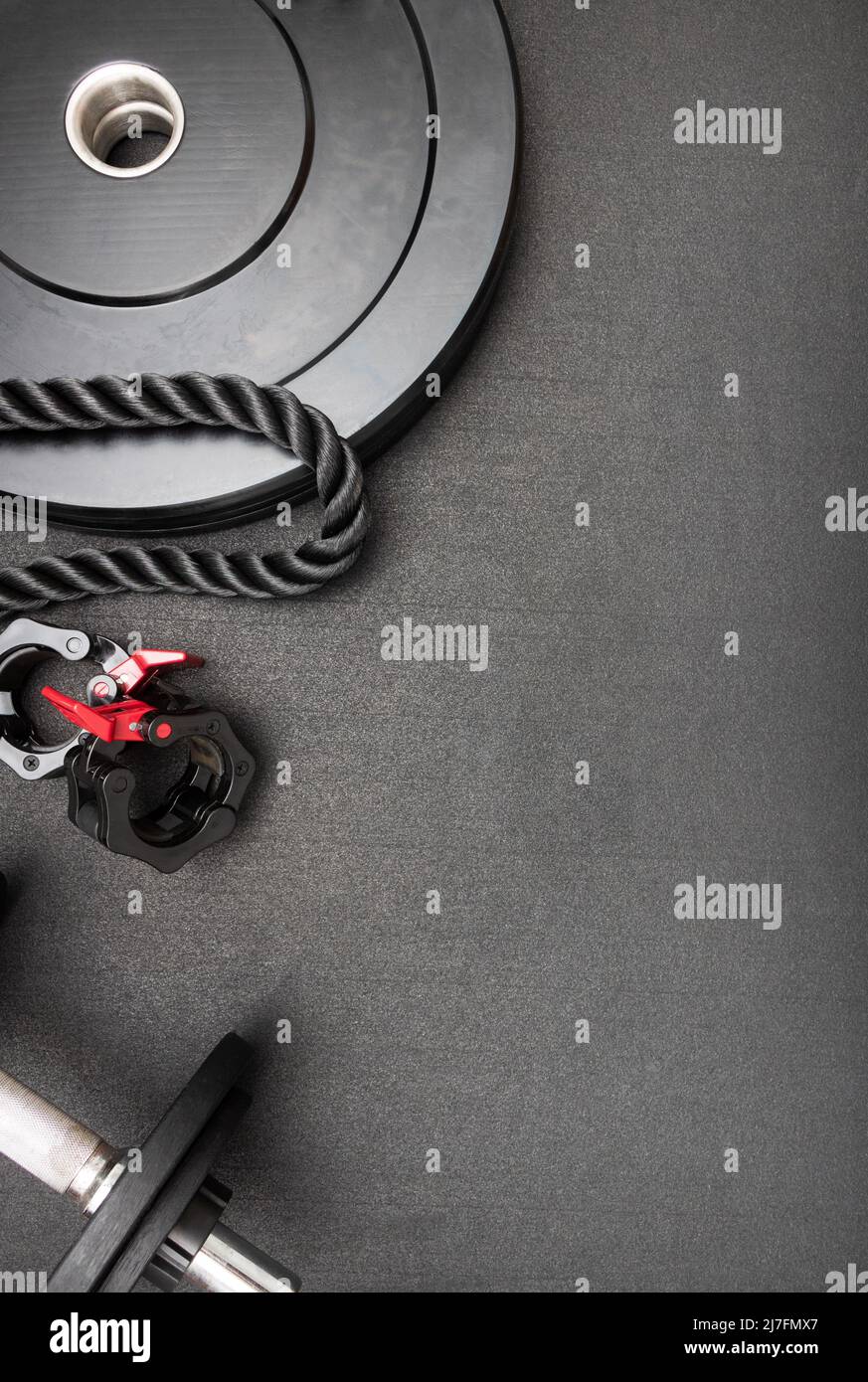 Barbell, dumbbells and accessories on the floor at the gym. Top down ...