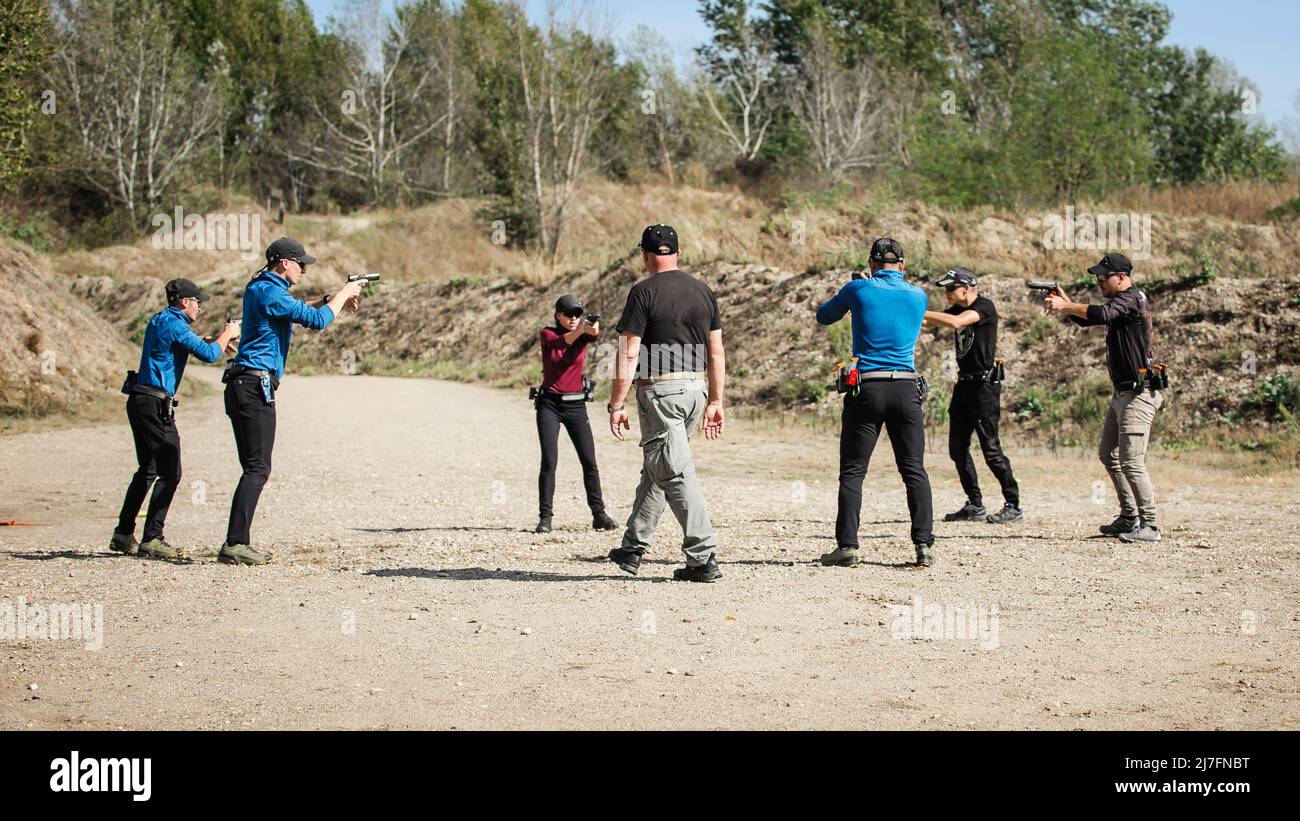 Group of students on training for handling and shooting in shooting ...