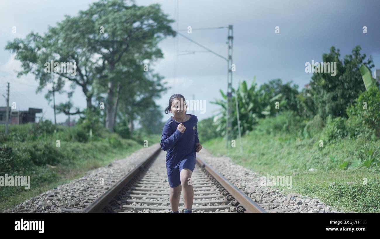 Indian Kid running on the railway track in the Himalayan range of India ...