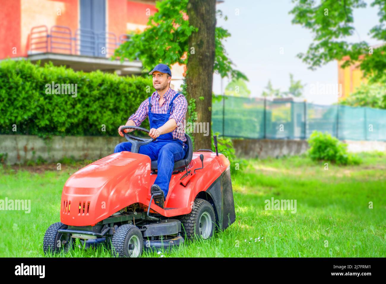 Man riding lawn mower hi-res stock photography and images - Alamy