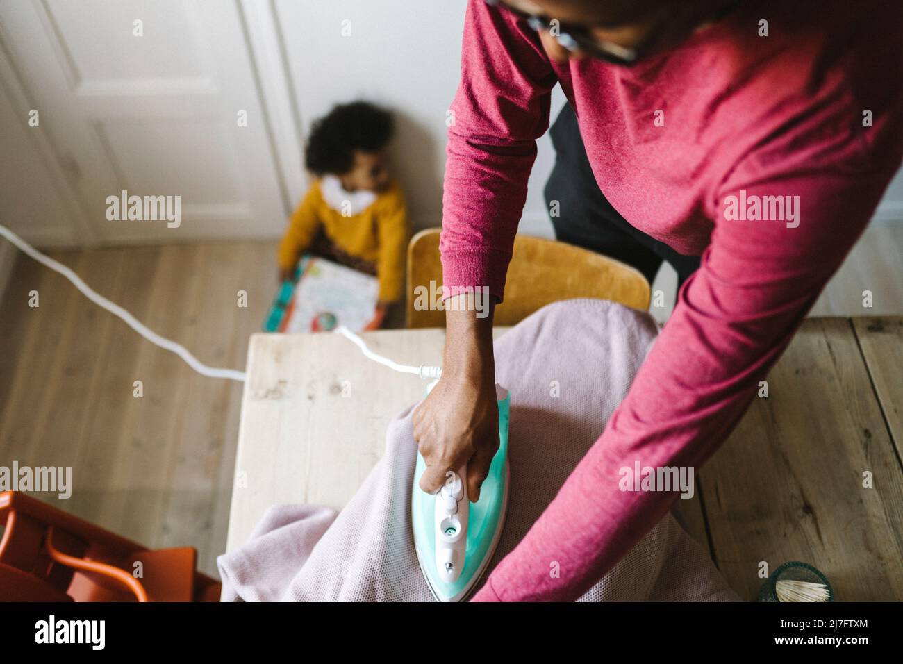 Father ironing clothes at home Stock Photo - Alamy