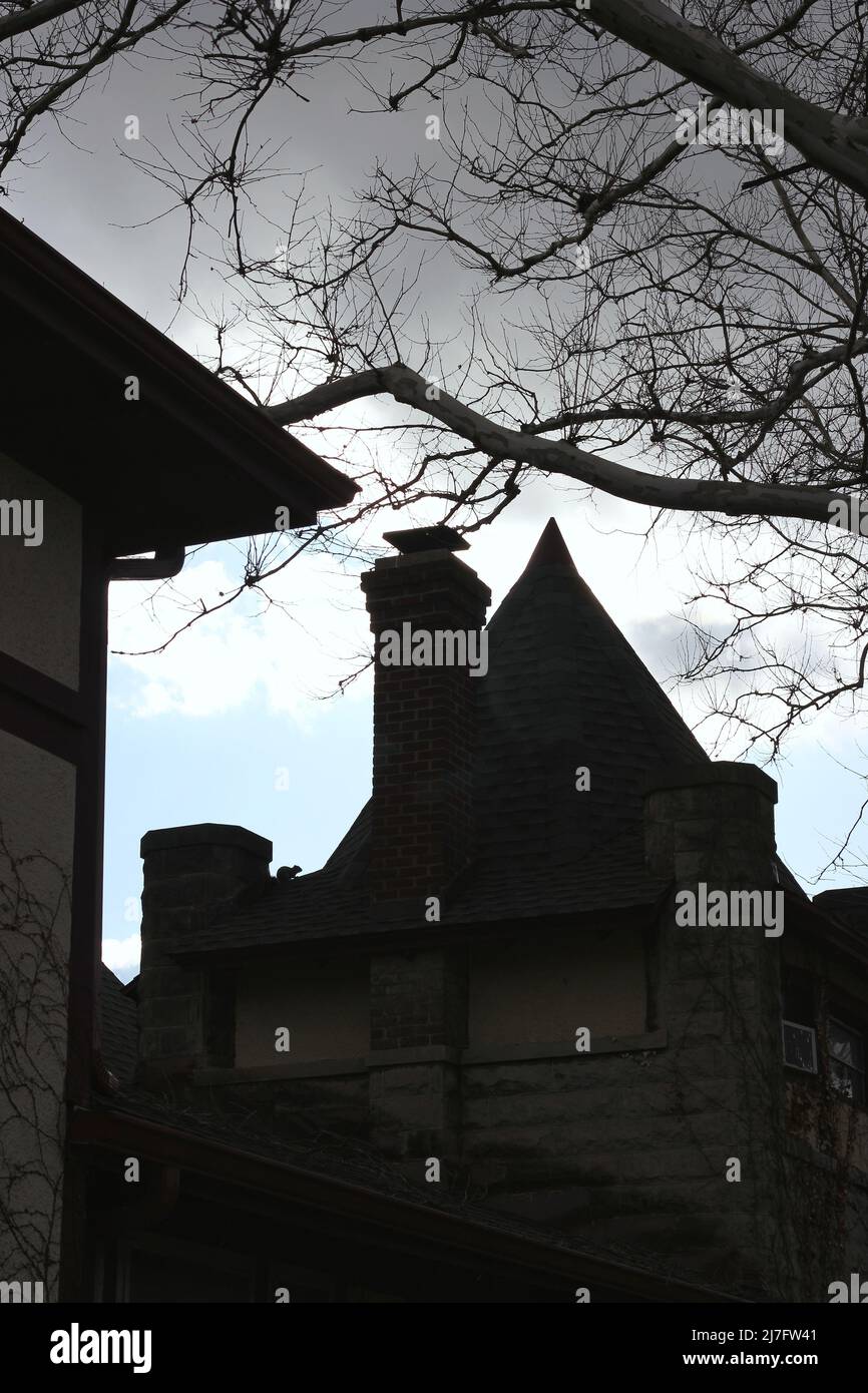 Scary eerie traditional colonial house with a chimney in silhouette ...