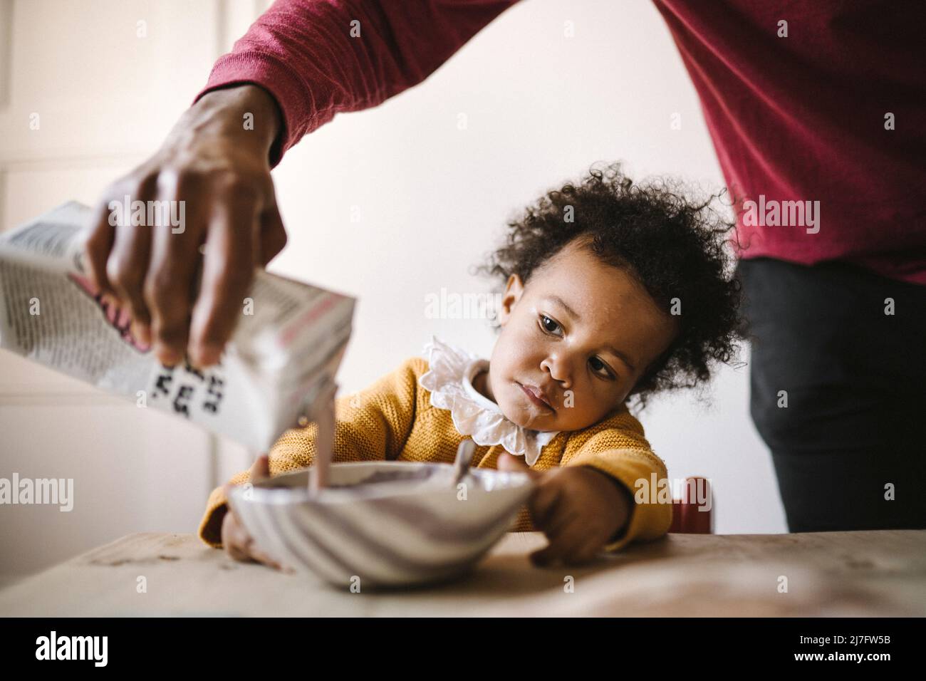 Child pouring milk hi-res stock photography and images - Alamy