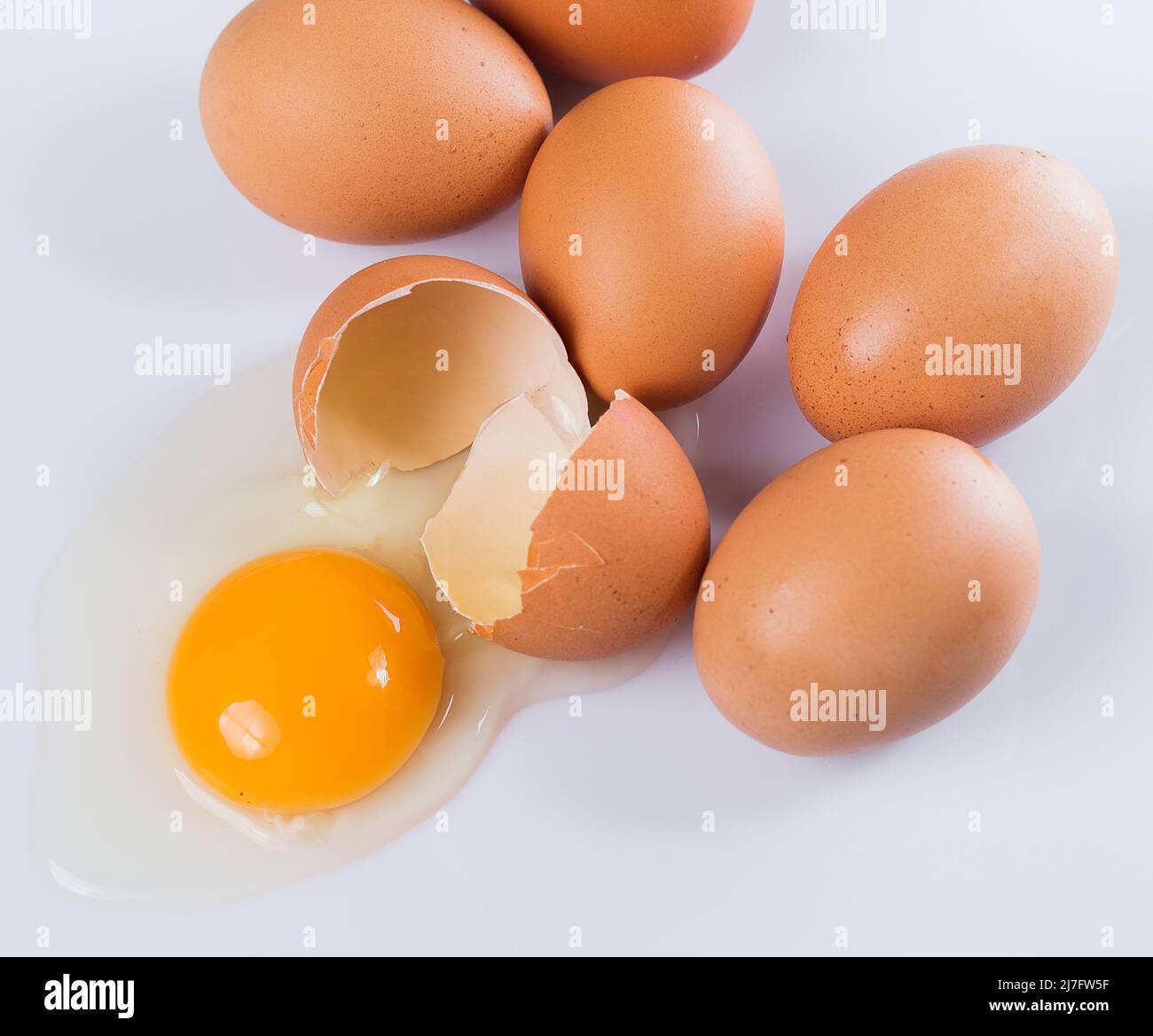 Closeup of cracked egg on white background Stock Photo - Alamy