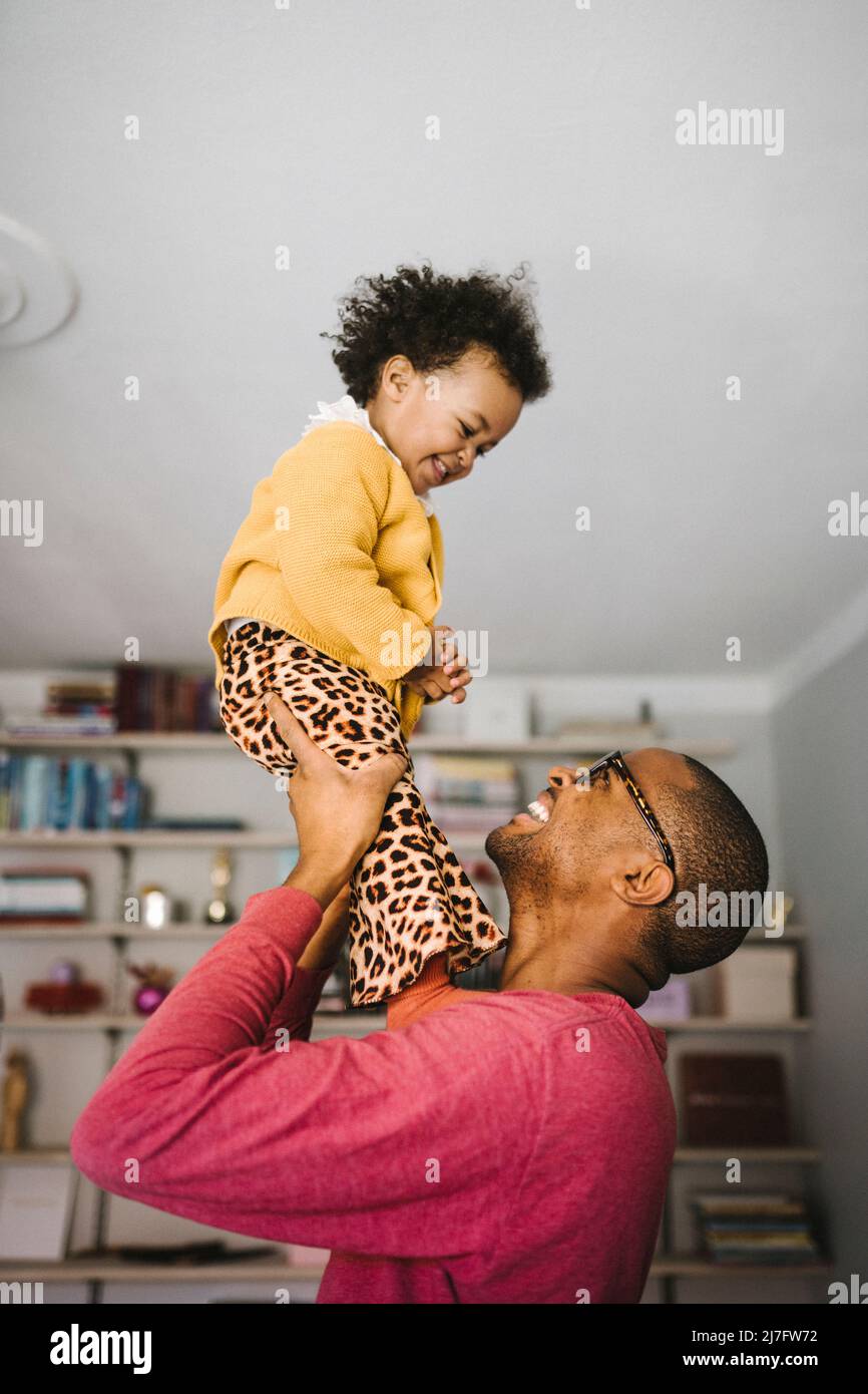 Young father lifting smiling daughter Stock Photo - Alamy