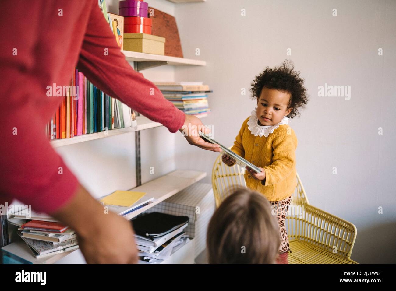 Father giving book to daughter Stock Photo - Alamy