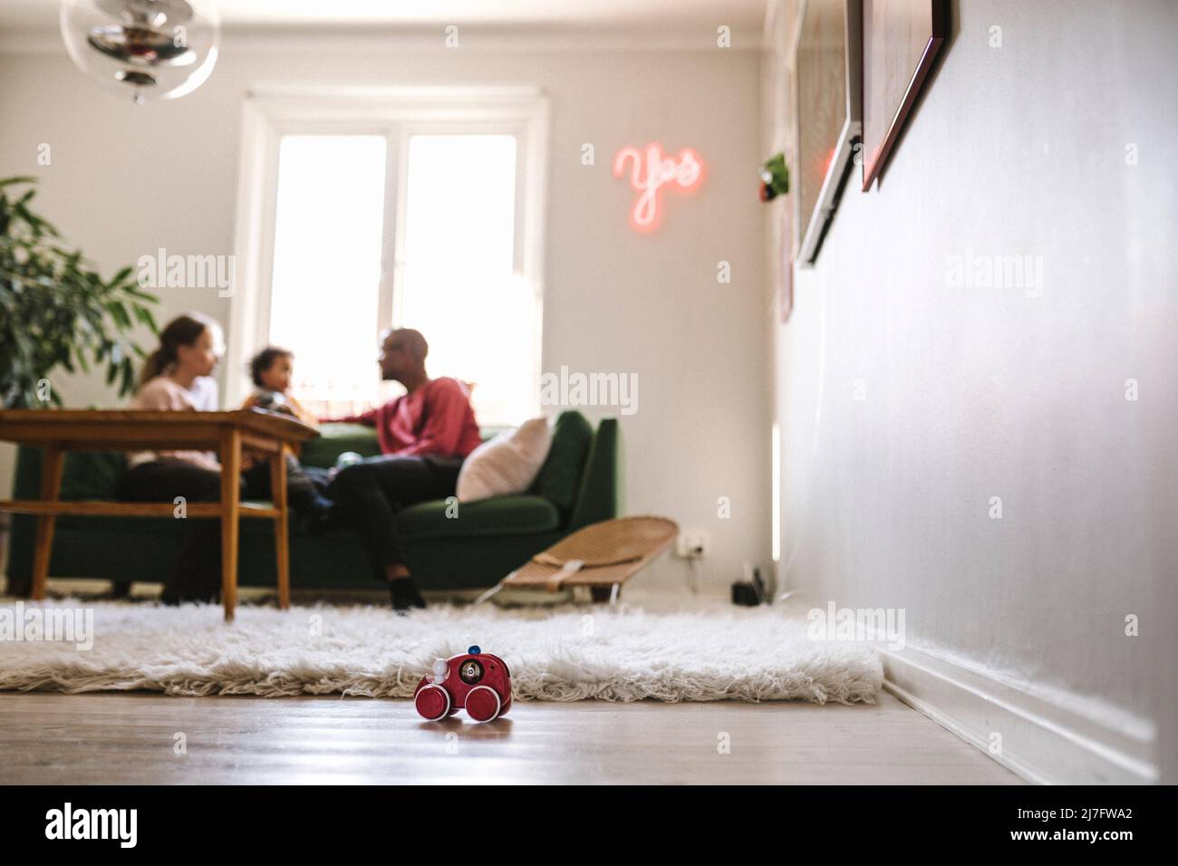 Parents and daughter relaxing at home Stock Photo - Alamy