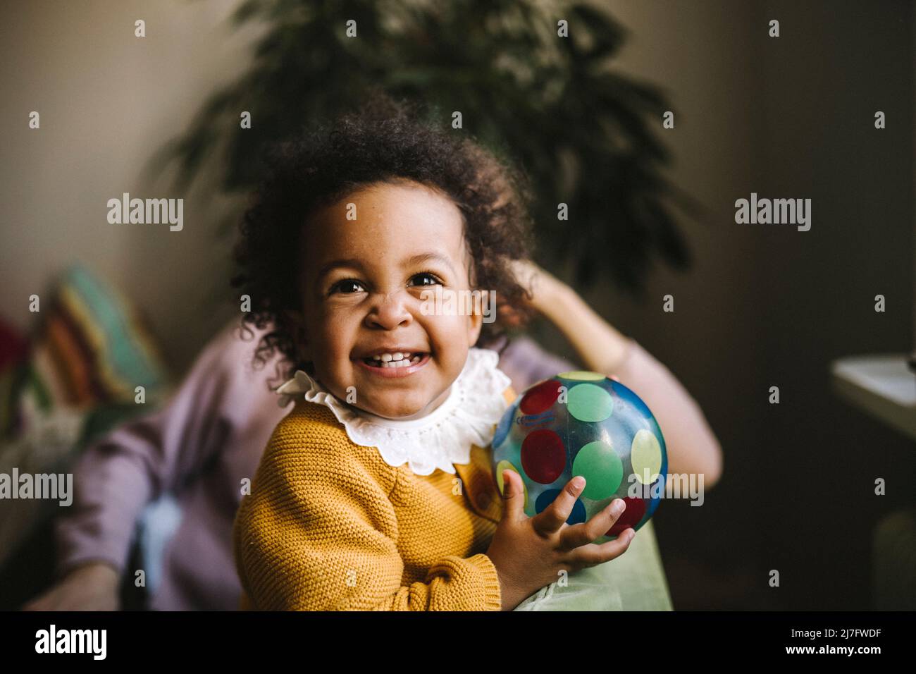 Happy girl holding ball hi-res stock photography and images - Alamy