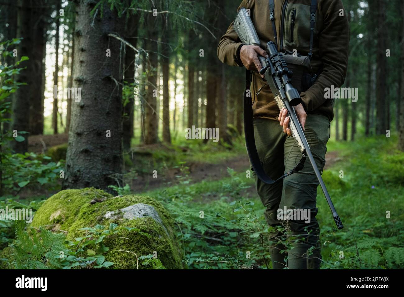 Mid section of hunter in forest Stock Photo - Alamy