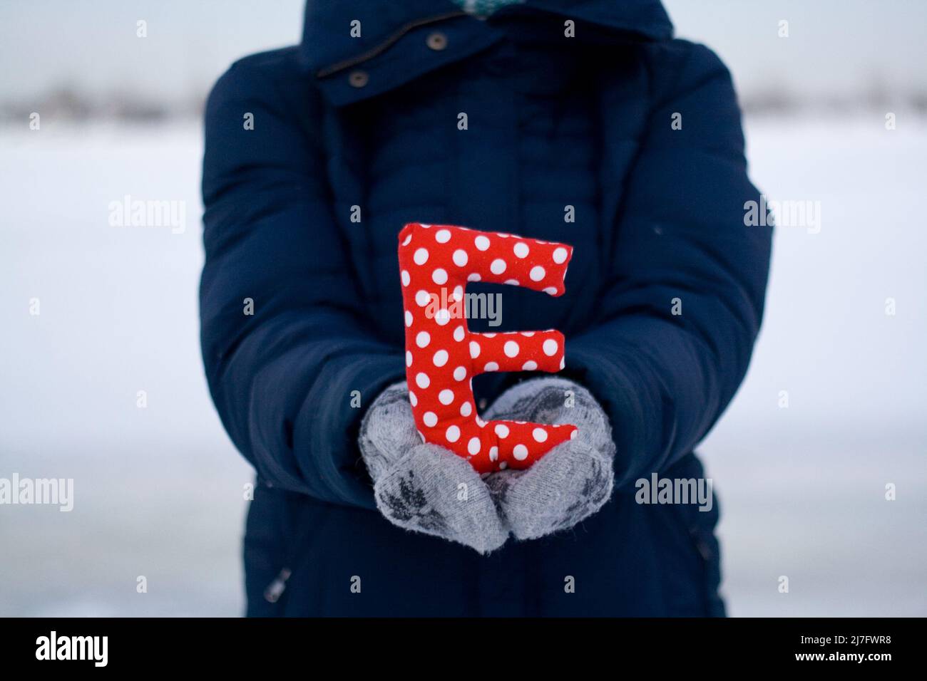 Girl In Blue Down Jacket And Gloves Holding A Letter Of Tissue E Stock