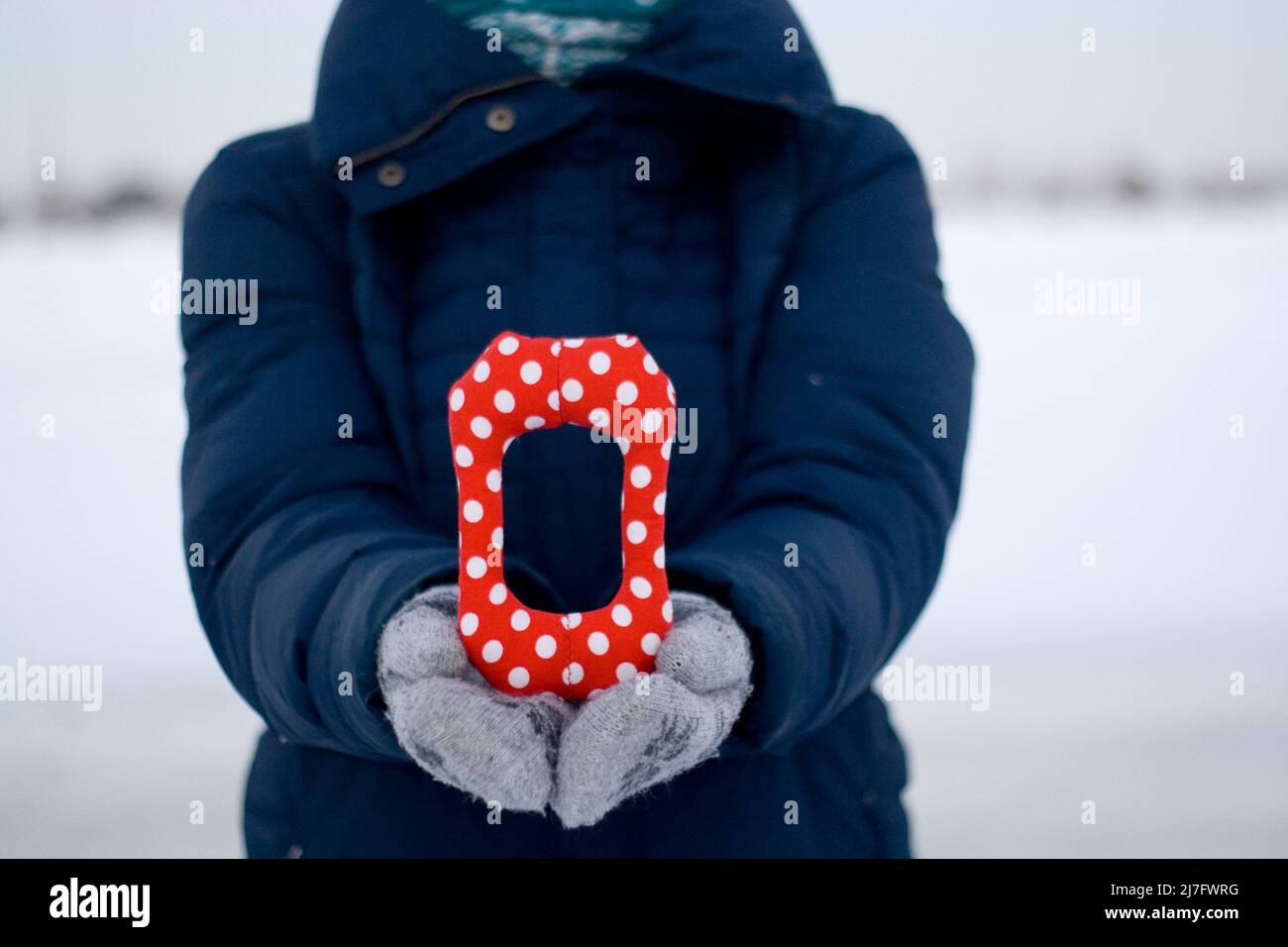 Girl In Blue Down Jacket And Gloves Holding A Letter Of Tissue O Stock