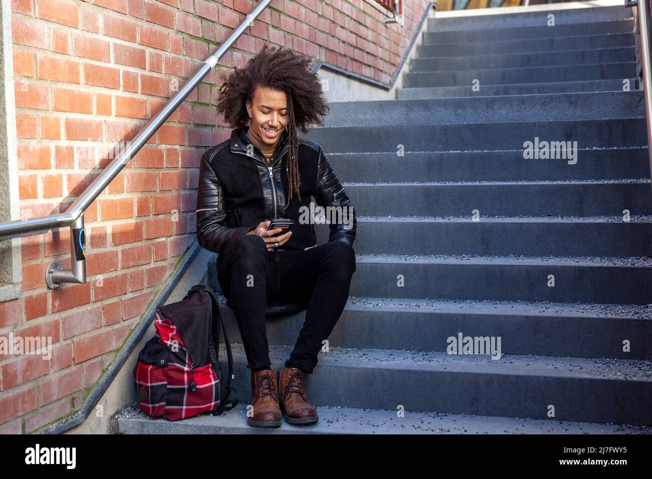 Young man using cell phone Stock Photo - Alamy
