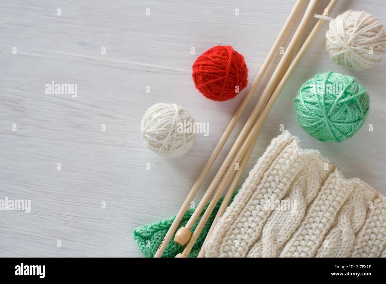 Two bright patterns, yarn balls and needles for knitting wooden white ...