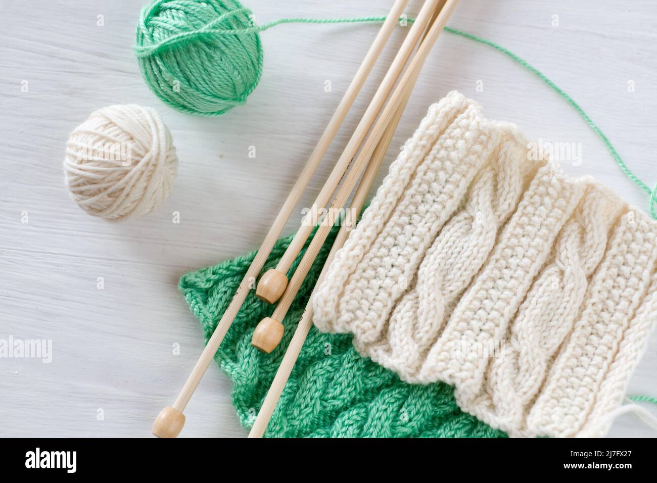 Two bright patterns, yarn balls and needles for knitting wooden white ...
