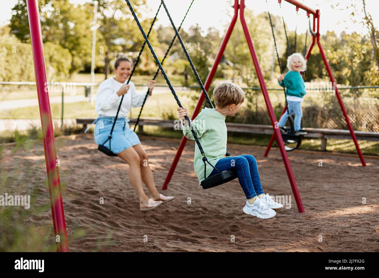 Mother with children on playground Stock Photo - Alamy