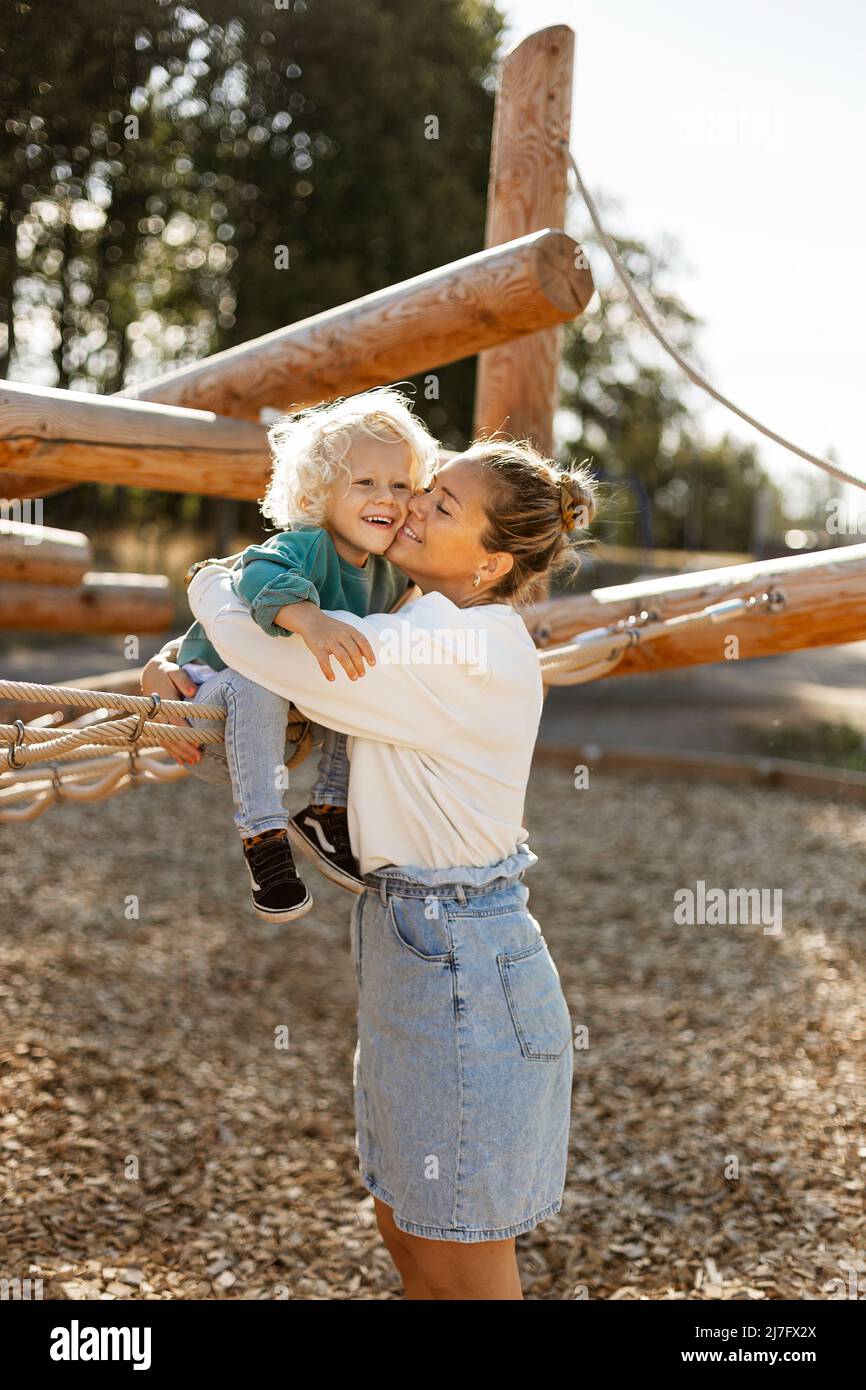 Mother with child on playground Stock Photo - Alamy