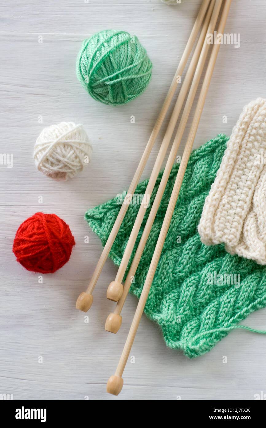 Two bright patterns, yarn balls and needles for knitting wooden white ...