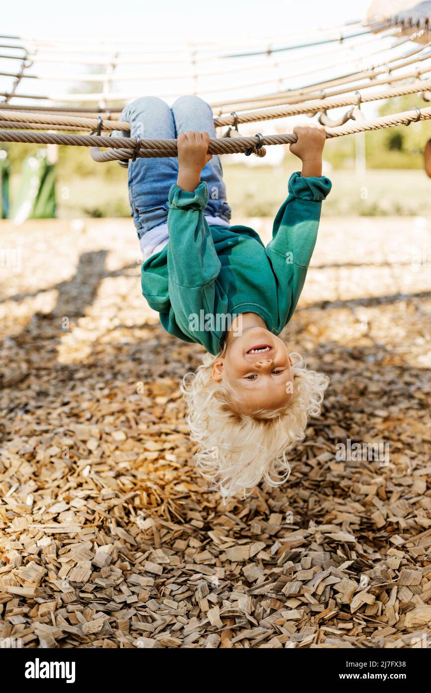 Happy child on climbing frame Stock Photo - Alamy