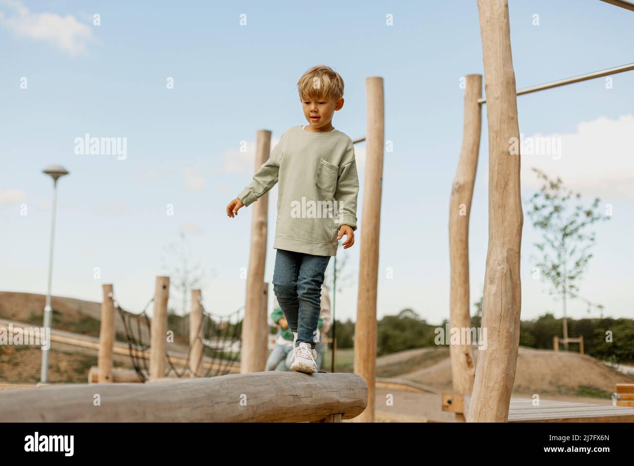 Boy playing at playground Stock Photo - Alamy