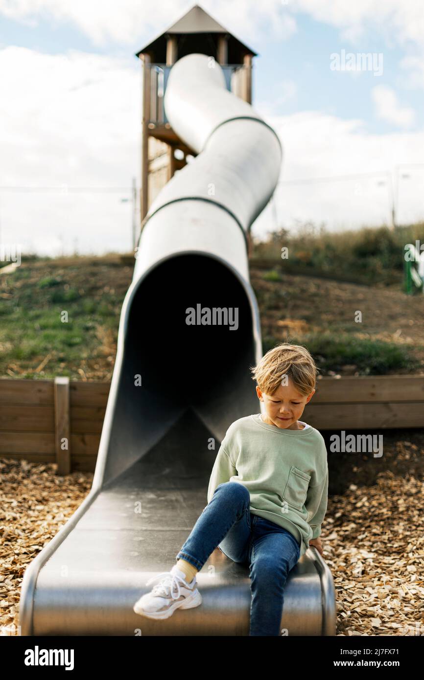 Boy playing at playground Stock Photo - Alamy