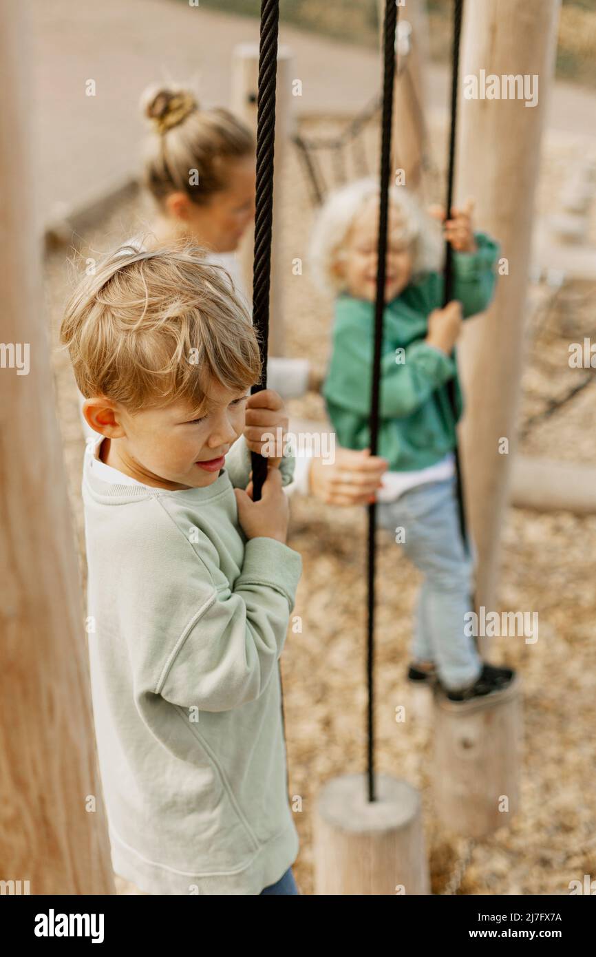Boy playing at playground Stock Photo - Alamy