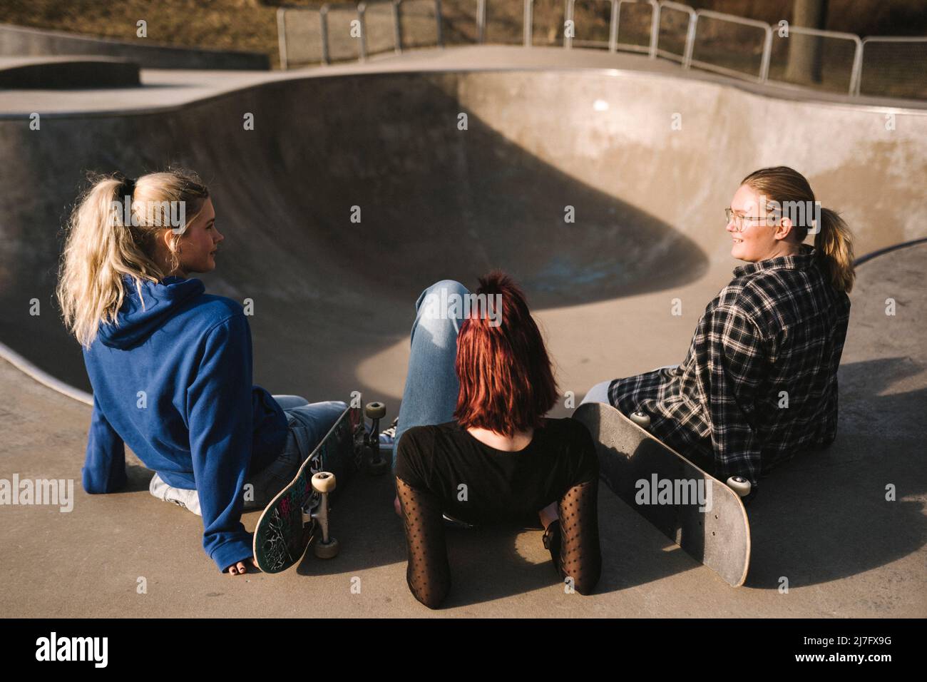 Teenage girls with skateboards sitting in skatepark Stock Photo - Alamy