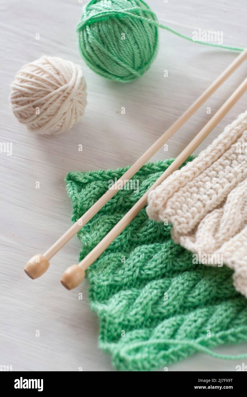 Two bright patterns and wooden knitting needles for a white background ...